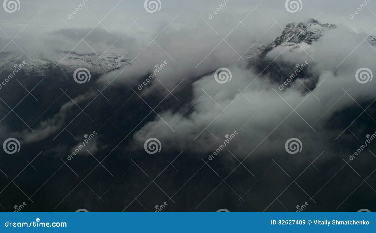 Timelapse of Grey High Blowing Snow Mountains with Storm Clouds and ...
