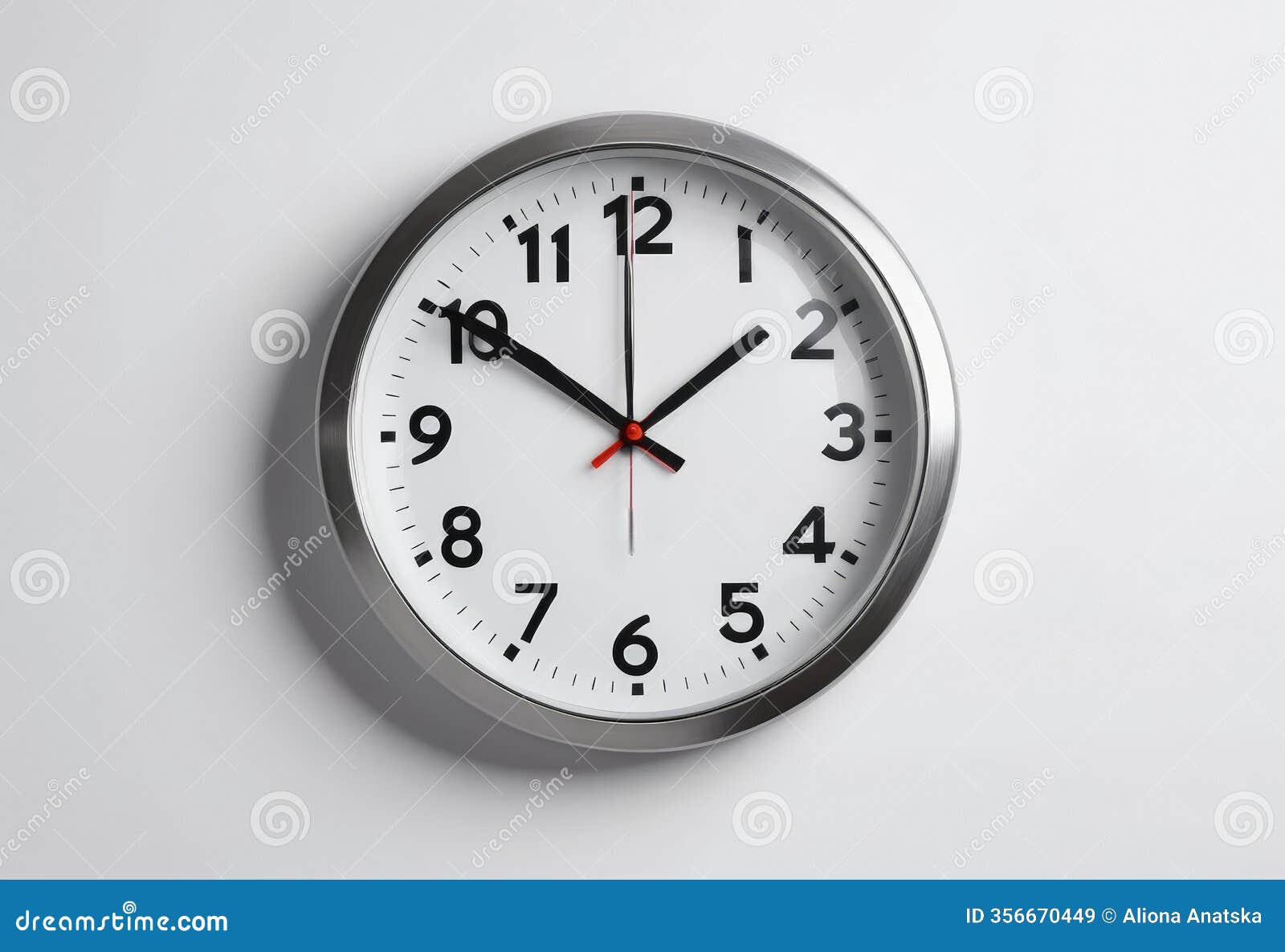 A Timeless Wall Clock Featuring a Silver Frame and Clear Markings ...