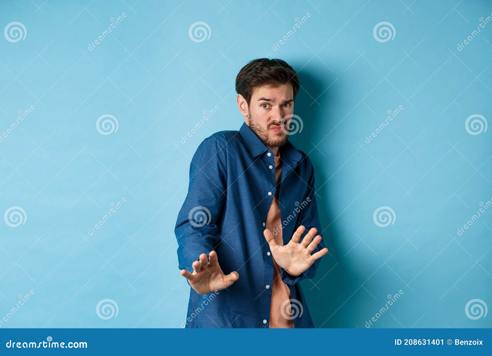 Timid Young Man Asking To Keep Away, Stretch Out Hands Defensive and ...