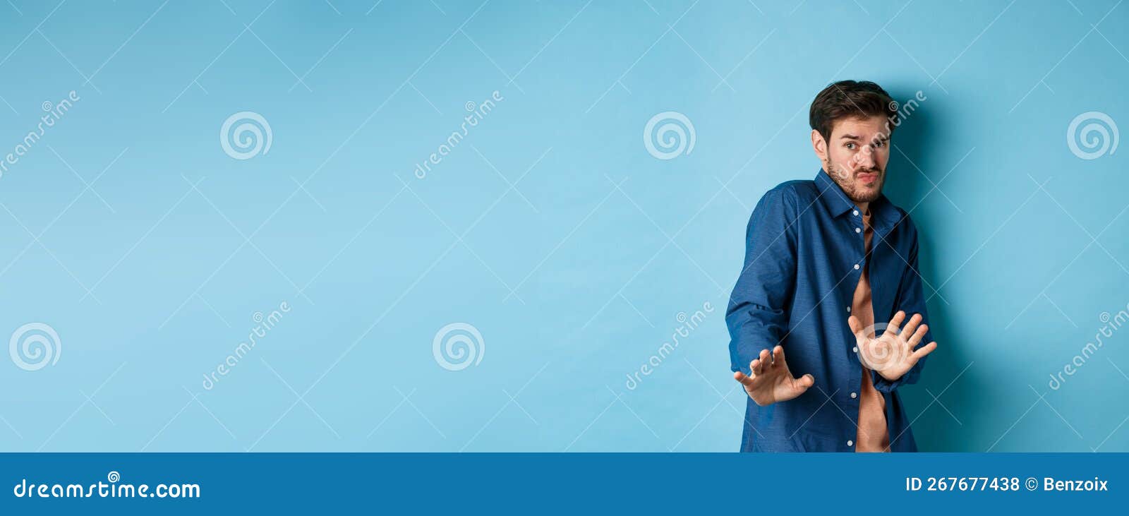 Timid Young Man Asking To Keep Away, Stretch Out Hands Defensive and ...