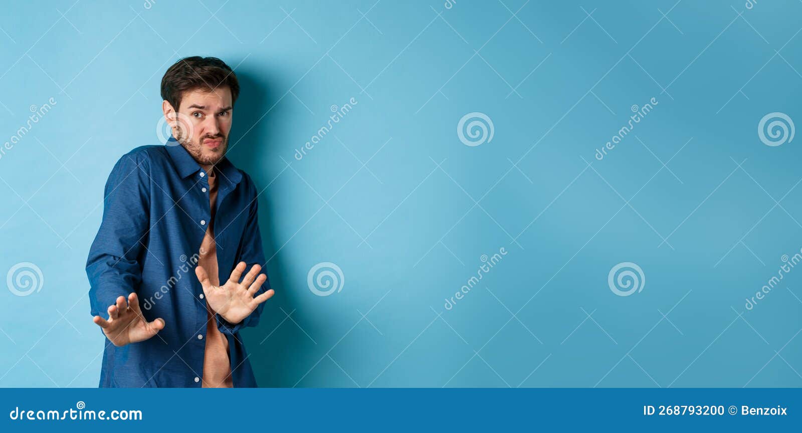 Timid Young Man Asking To Keep Away, Stretch Out Hands Defensive and ...