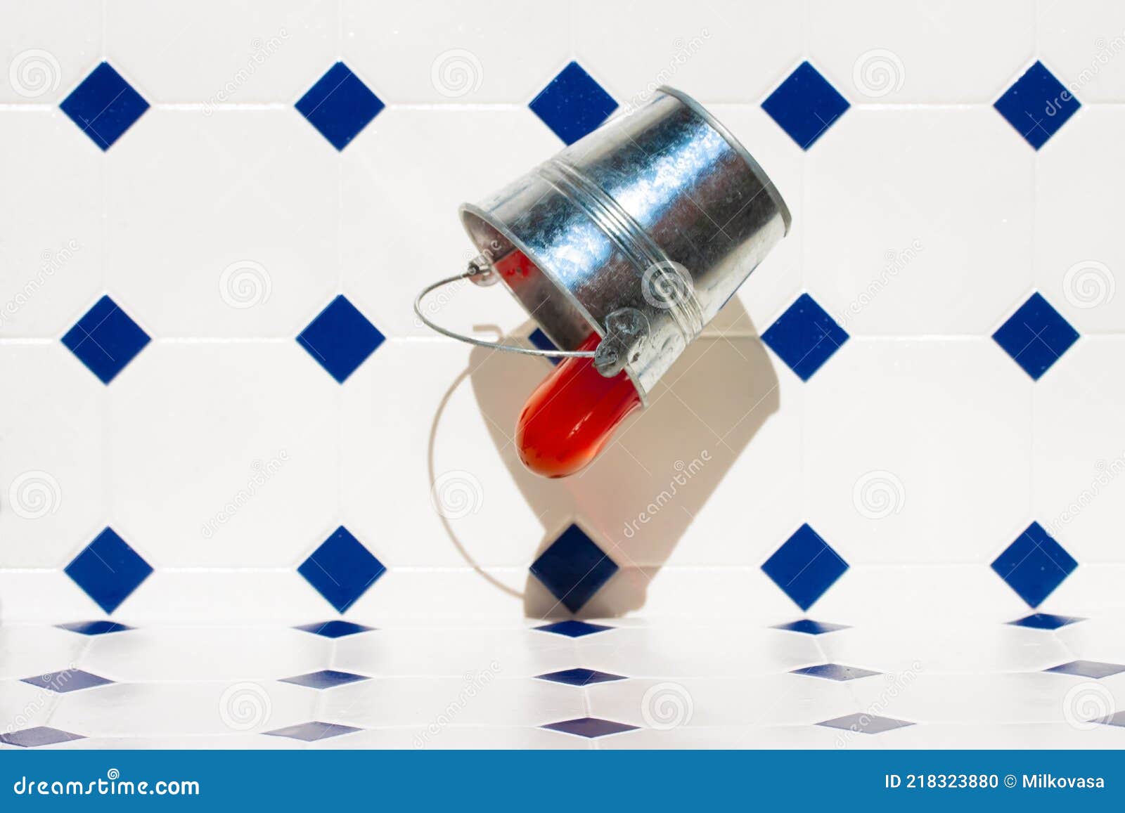 A Tin Bucket Falling To the Floor and a Red Liquid Flows from it Stock ...