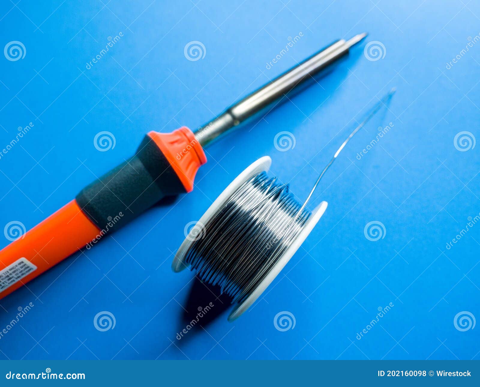 Tin Soldering Iron Tool with a Tin Roll on a Blue Surface Stock Photo ...