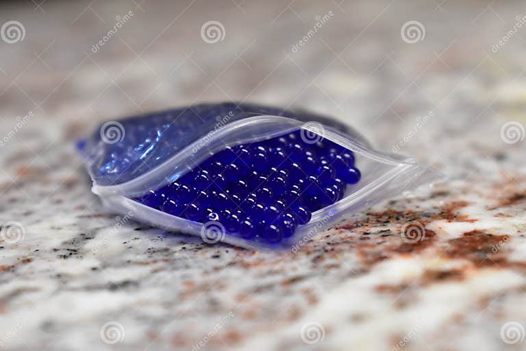 Tiny Blue Orbs in a Plastic Pouch Stock Photo - Image of decoration ...