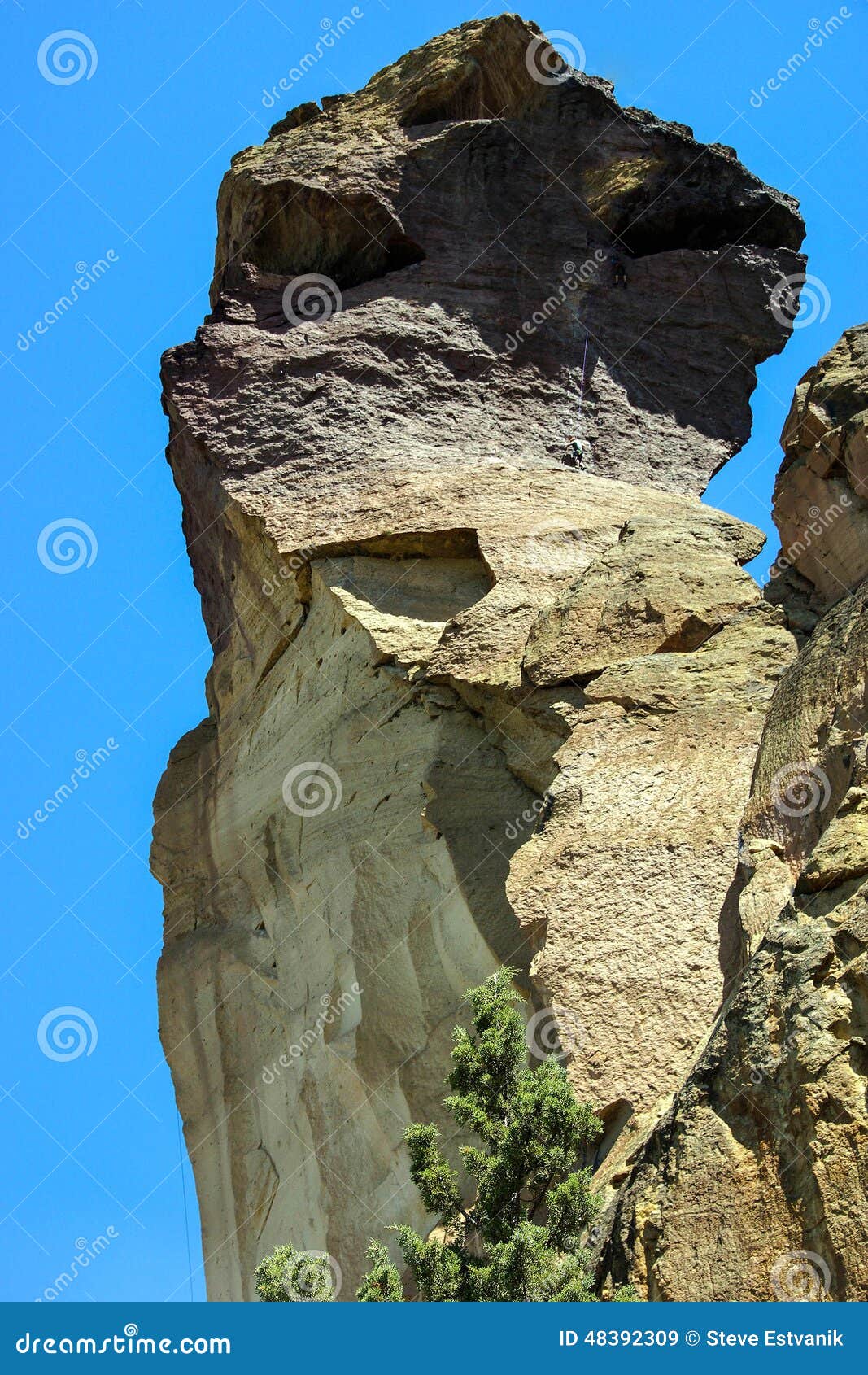 Tiny Climbers on Overhanging Cliff Stock Image - Image of rhyolite ...