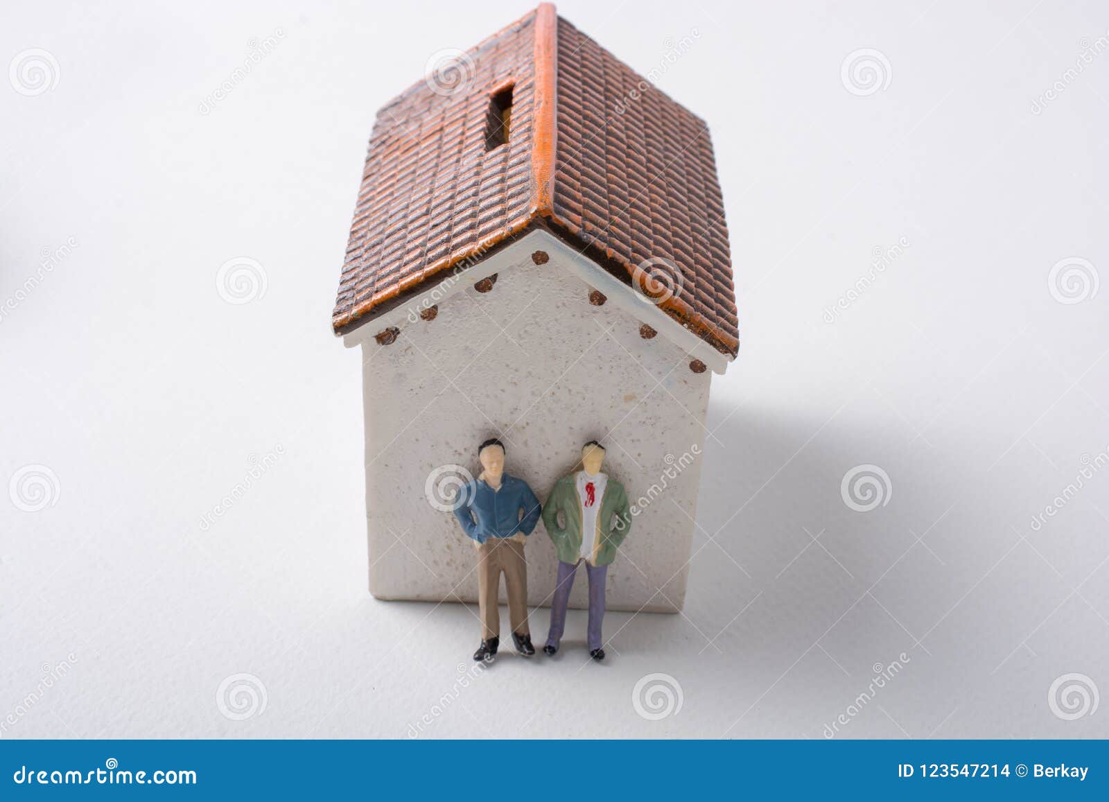 Tiny Figurine of Men in Front of a House Stock Photo - Image of hands ...