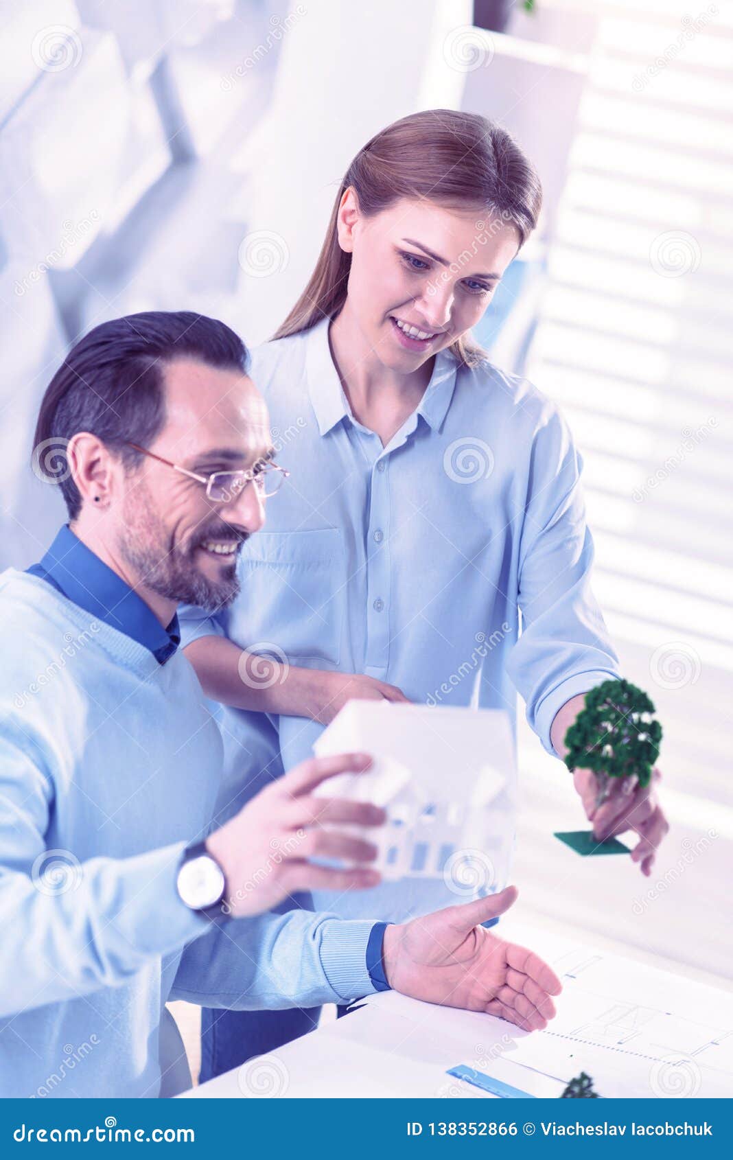 Friendly Engineers Smiling and Looking Interested while Working with ...