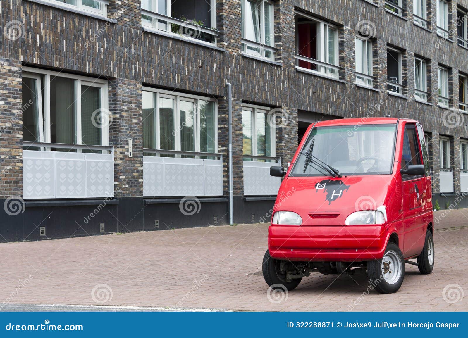 Tiny Red Car by a Building Made of Bricks Editorial Photo - Image of ...