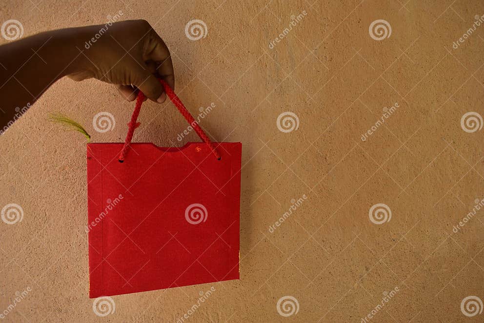 A Tiny Red Colored Beg Made of Hard Paper. Which is Use To Gift Packing ...