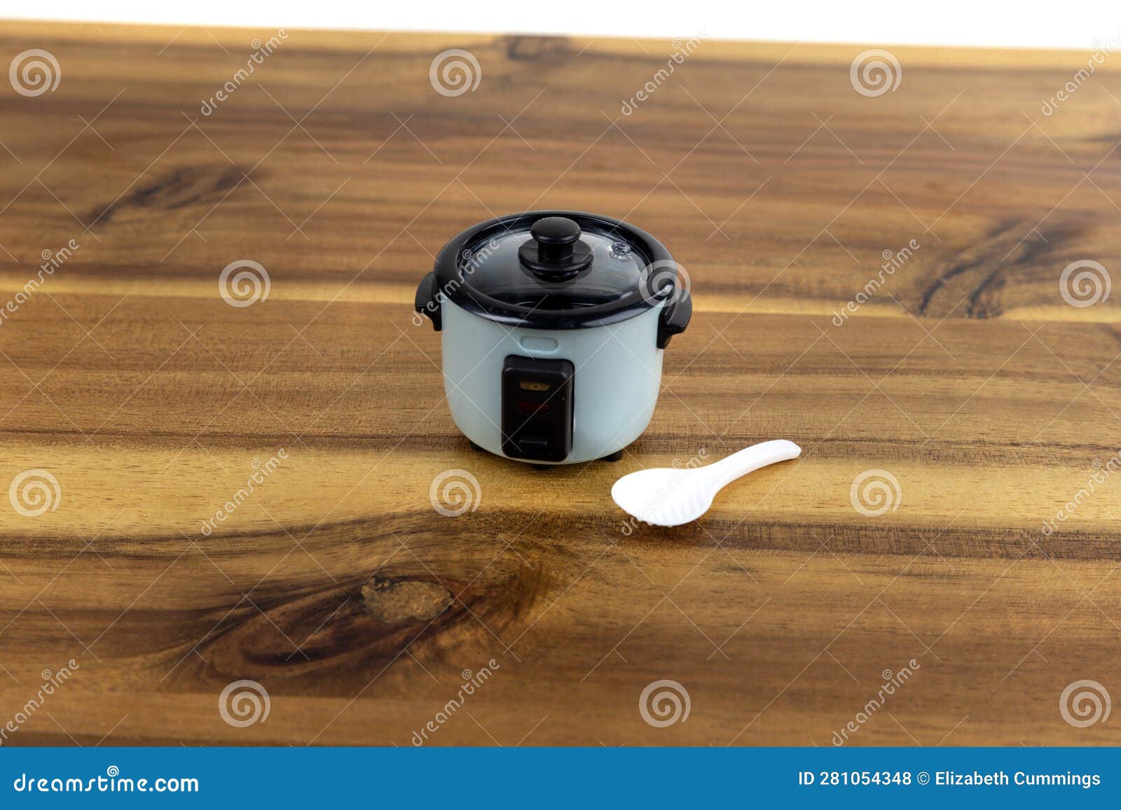 Tiny Toy Rice Cooker and Scoop Over a Wood Background Stock Photo ...