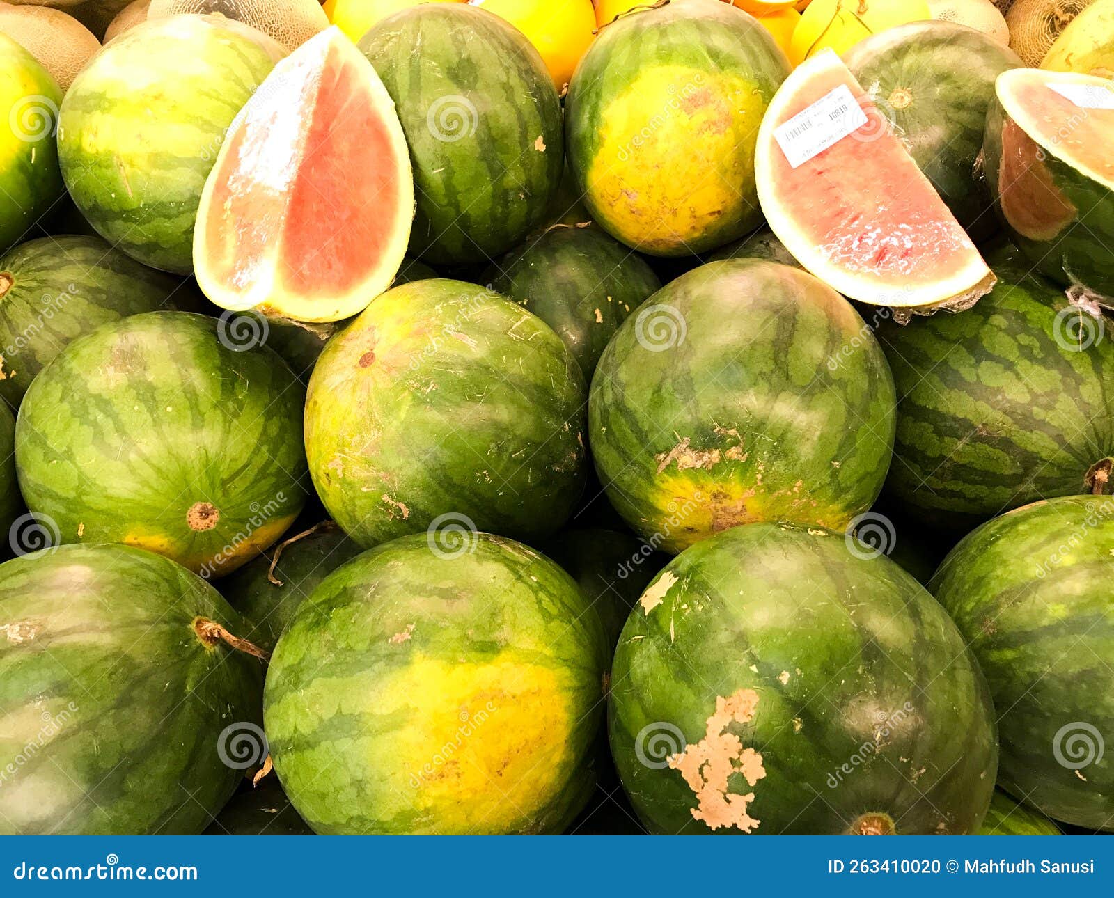 A Tiny Unripe Watermelon and Big Watermelon on Back Stock Photo - Image ...
