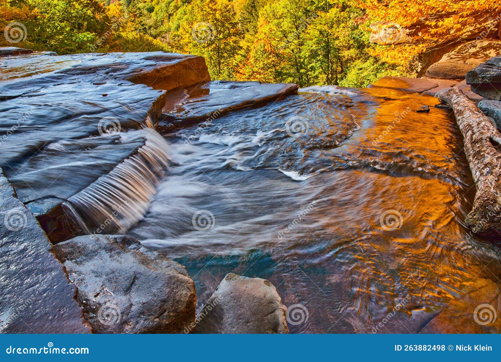 Tiny Waterfall Over Rocks Leading To Cliff Edge and Fall Foliage Stock ...