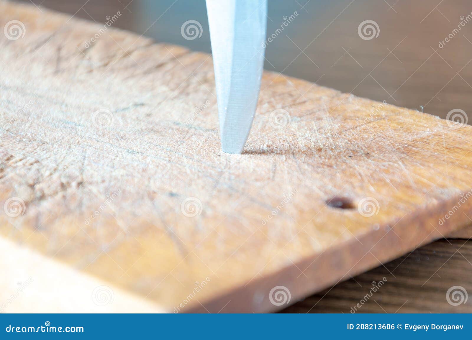 The Tip of the Knife is Stuck into a Cutting Board Stock Photo - Image ...