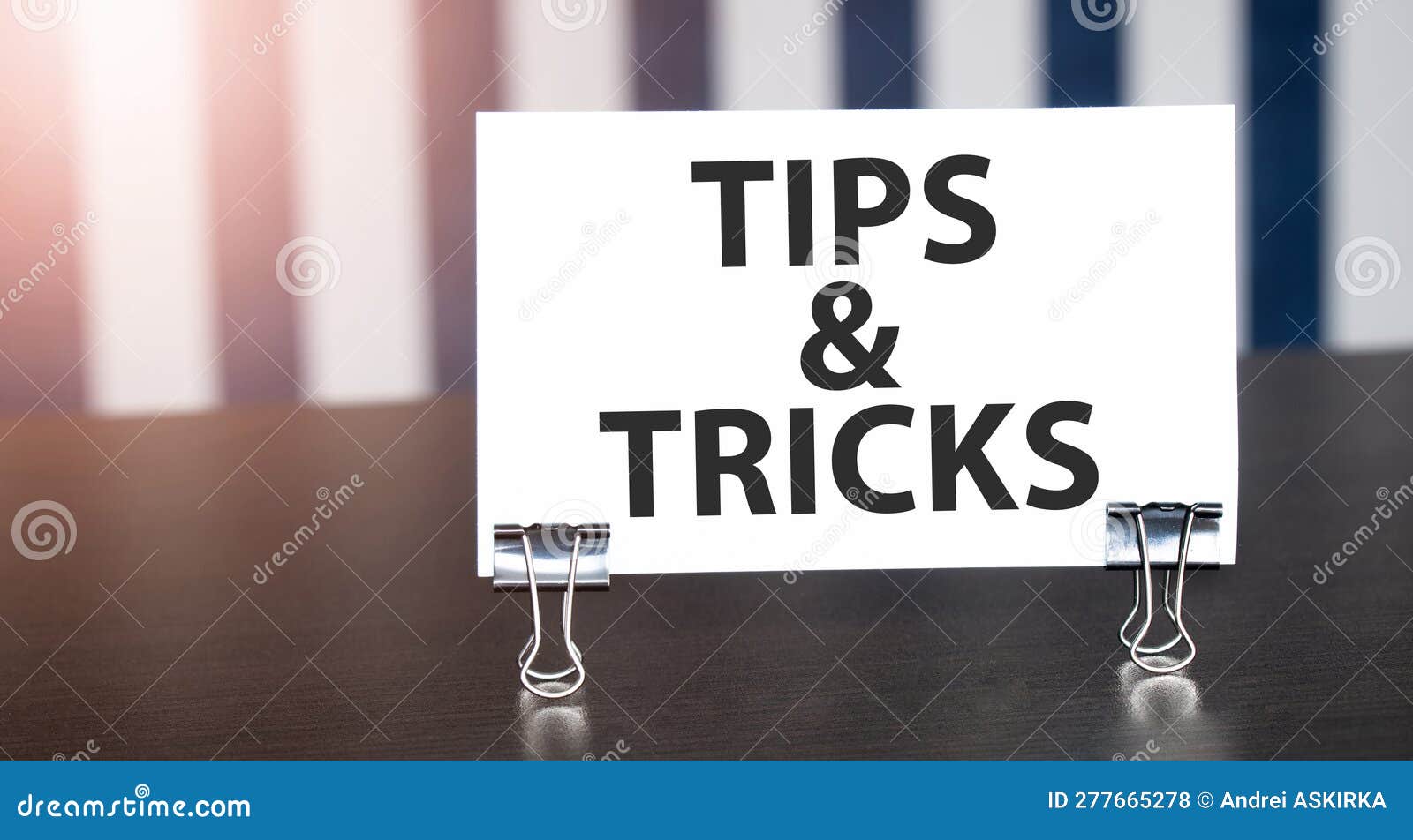TIPS and TRICKS Sign on Paper on Dark Desk in Sunlight. Blue and White ...