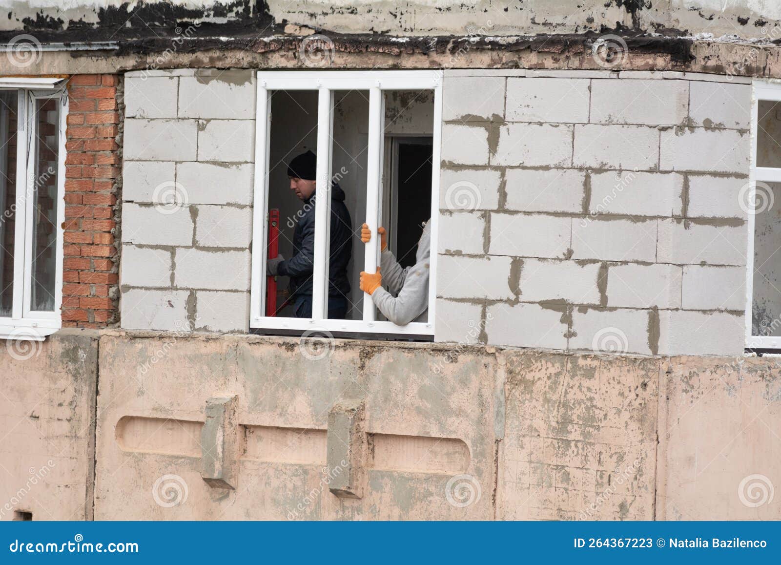 Worker with the Help of a Red Level, Checks the Correct Installation of ...