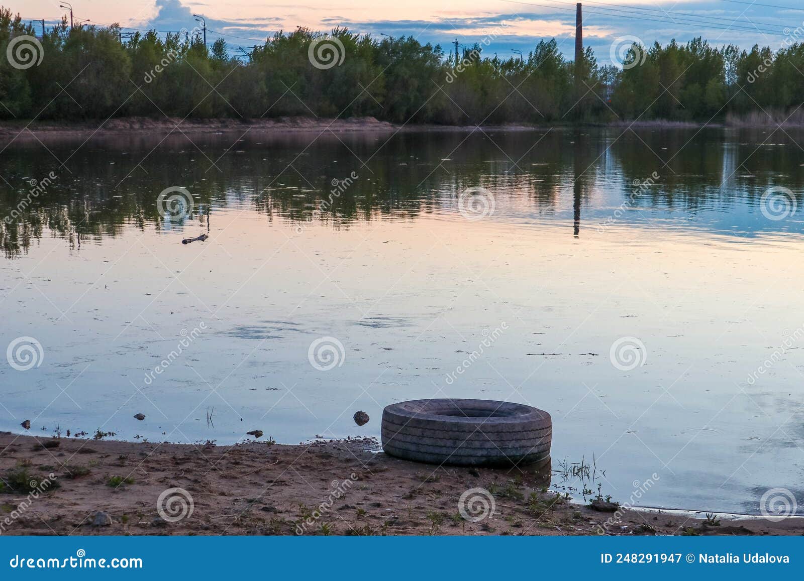 A tire on the river bank. stock image. Image of garbage - 248291947