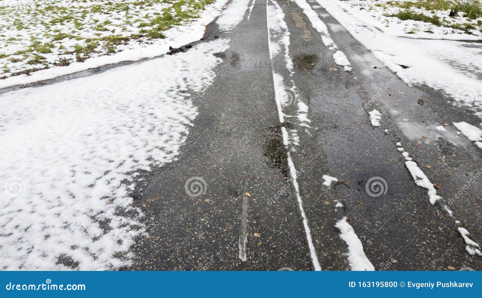 Tire Tracks in the Melting Snow on Asphalt Road Stock Photo - Image of ...