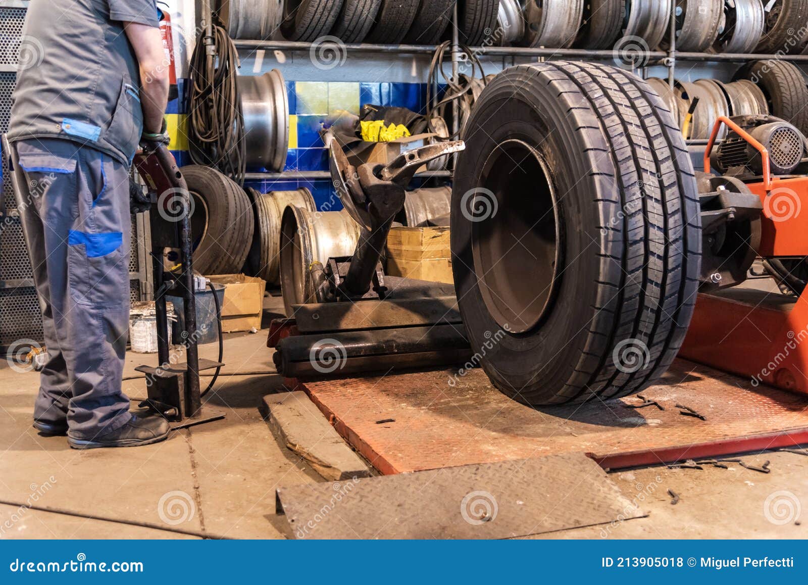 Tire workshop operator stock photo. Image of remove - 213905018