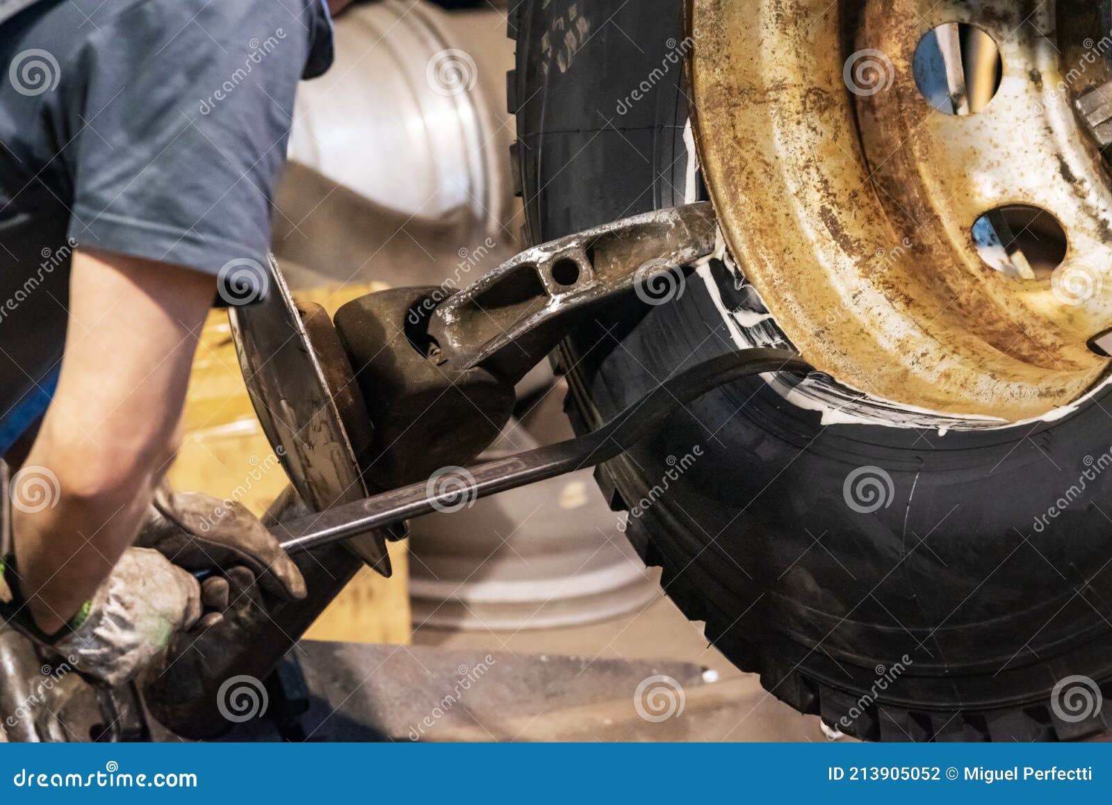 Tire workshop operator stock photo. Image of maintenance - 213905052