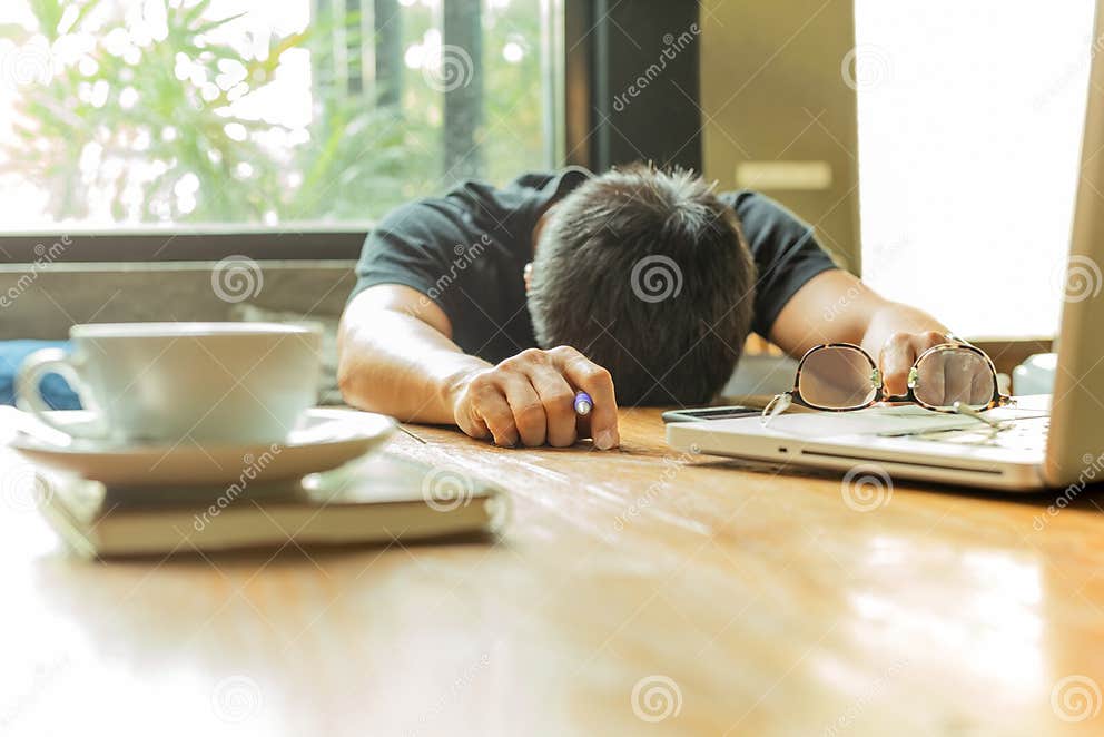 Tired Asian Man with Head Down on Computer Laptop while Working. Stock ...