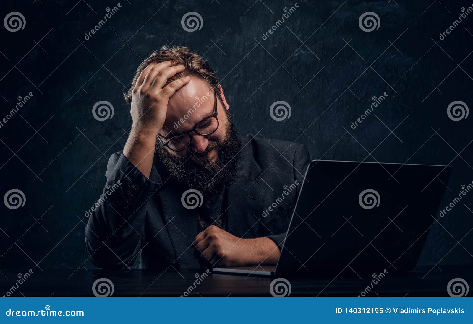Tired Bearded Programmer Sitting at the Table with Laptop in Office ... Tired Bearded Programmer Sitting at the Table with Laptop in Office ...