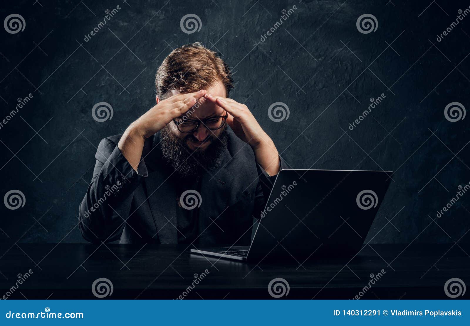 Tired Bearded Programmer Sitting at the Table with Laptop in Office ... Tired Bearded Programmer Sitting at the Table with Laptop in Office ...