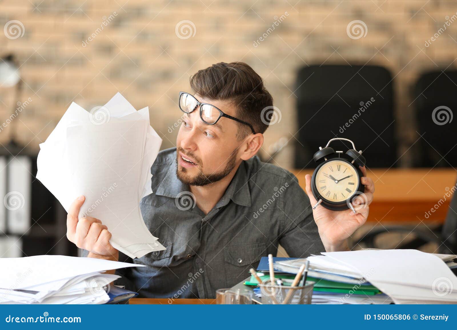 Tired Businessman with Alarm Clock and Documents in Office. Time ...