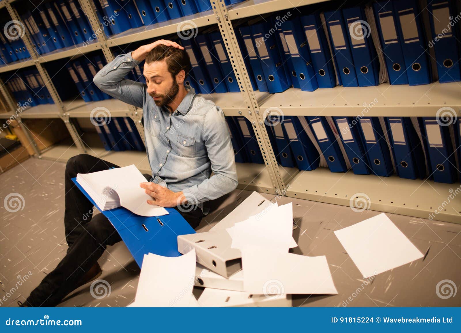 Tired Businessman with Scattered Papers in File Storage Room Stock ...