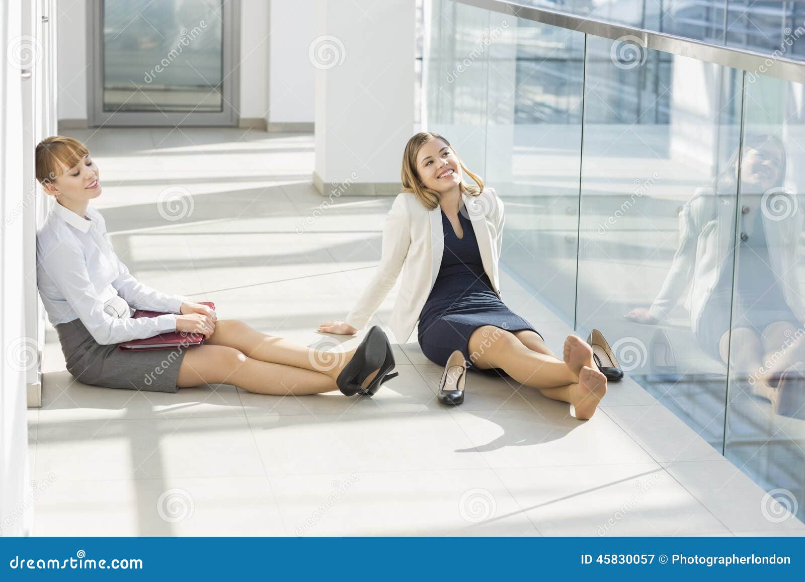 Tired Businesswoman Relaxing at Office Hallway Stock Image - Image of ... Tired Businesswoman Relaxing at Office Hallway Stock Image - Image of ...
