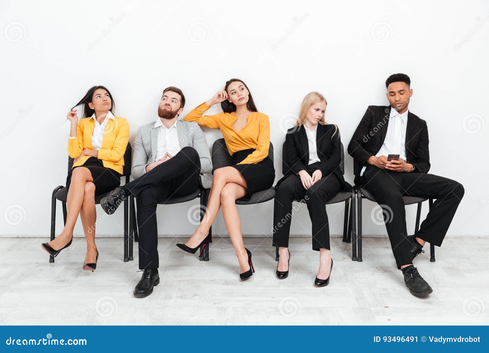Tired Colleagues Sitting in Office while Looking Aside. Stock Image ...