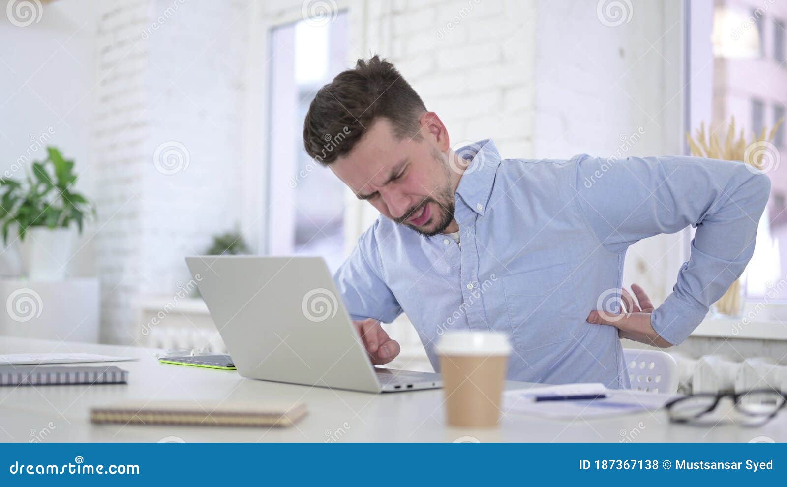 Tired Creative Young Man Having Back Pain at Work Stock Photo - Image ...