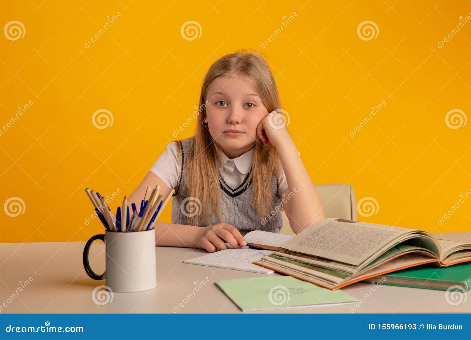 Tired Cute Girl at the Desk Doing Homework. Stock Image - Image of ...