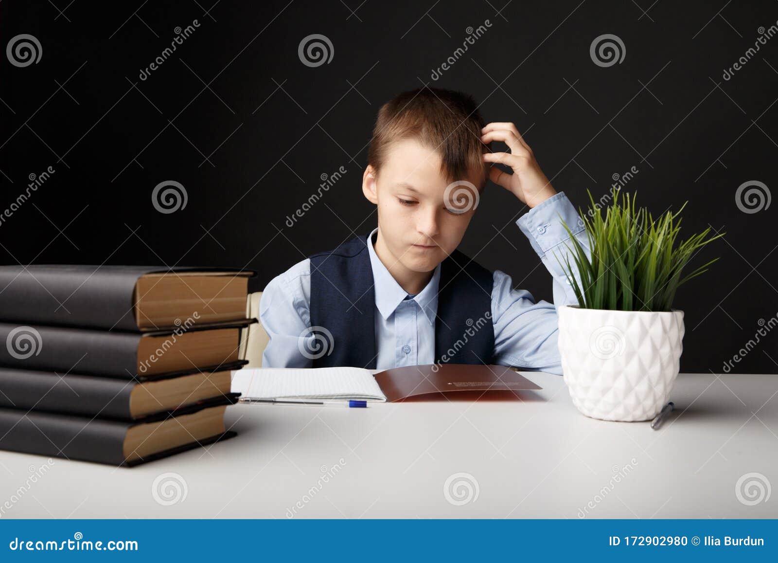 Tired and Depressed School Boy Sitting at the Desk and Studying Alone ...