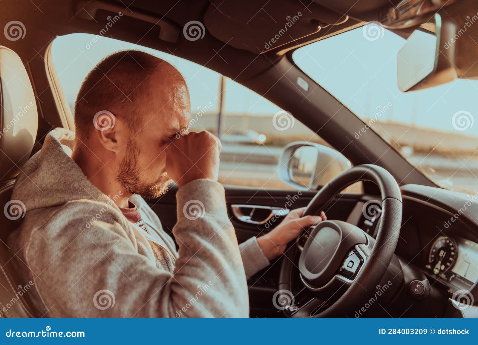 A Tired Driver Holding His Head. Exhausted and Tired Driver Driving a ...