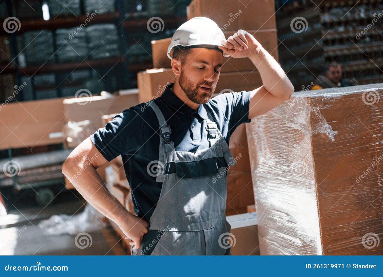 Tired Employee in Uniform is Working in the Dark Storage Stock Image ...
