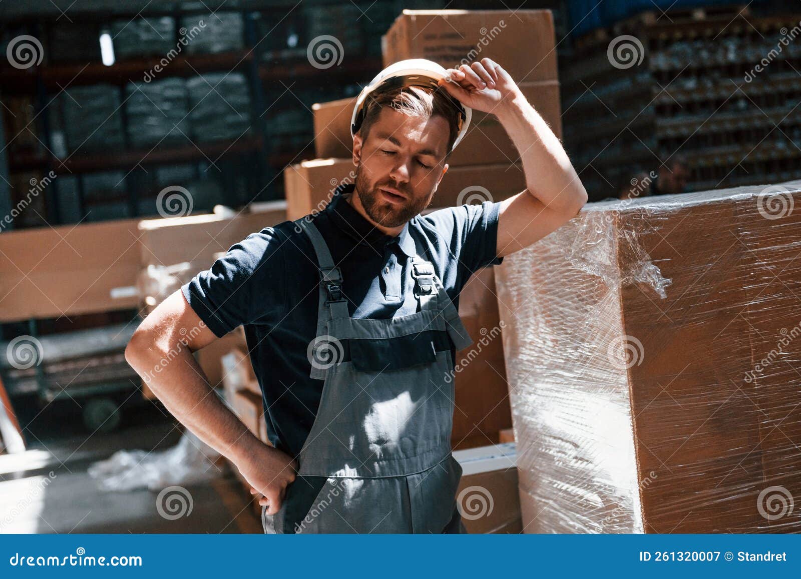 Tired Employee in Uniform is Working in the Dark Storage Stock Image ...