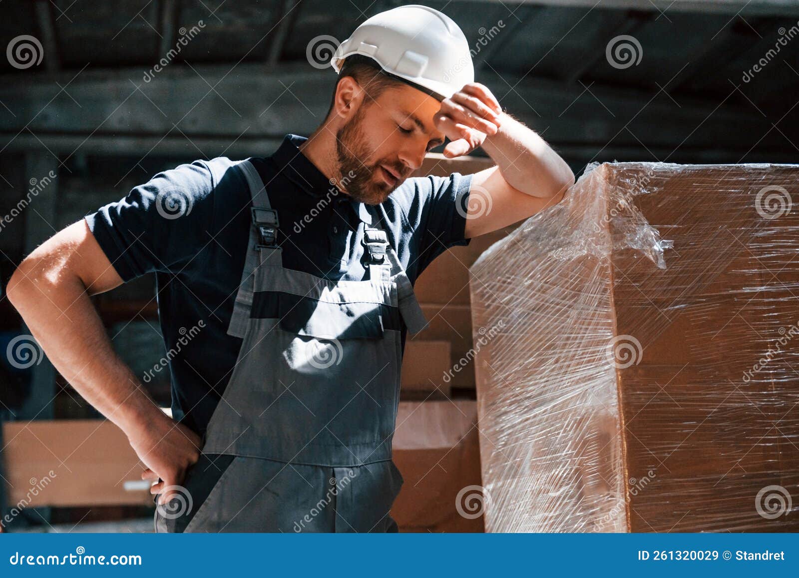 Tired Employee in Uniform is Working in the Dark Storage Stock Image ...