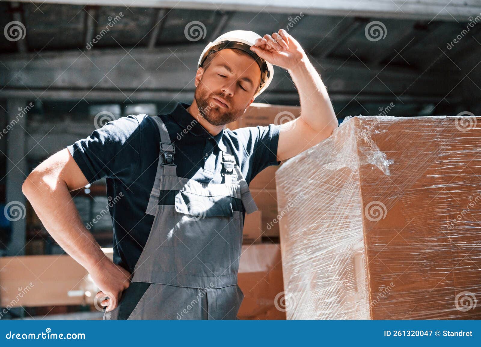 Tired Employee in Uniform is Working in the Dark Storage Stock Image ...