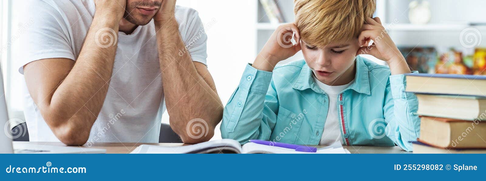 The Tired Father and a Son Doing Homework at the Desk. Stock Photo ...