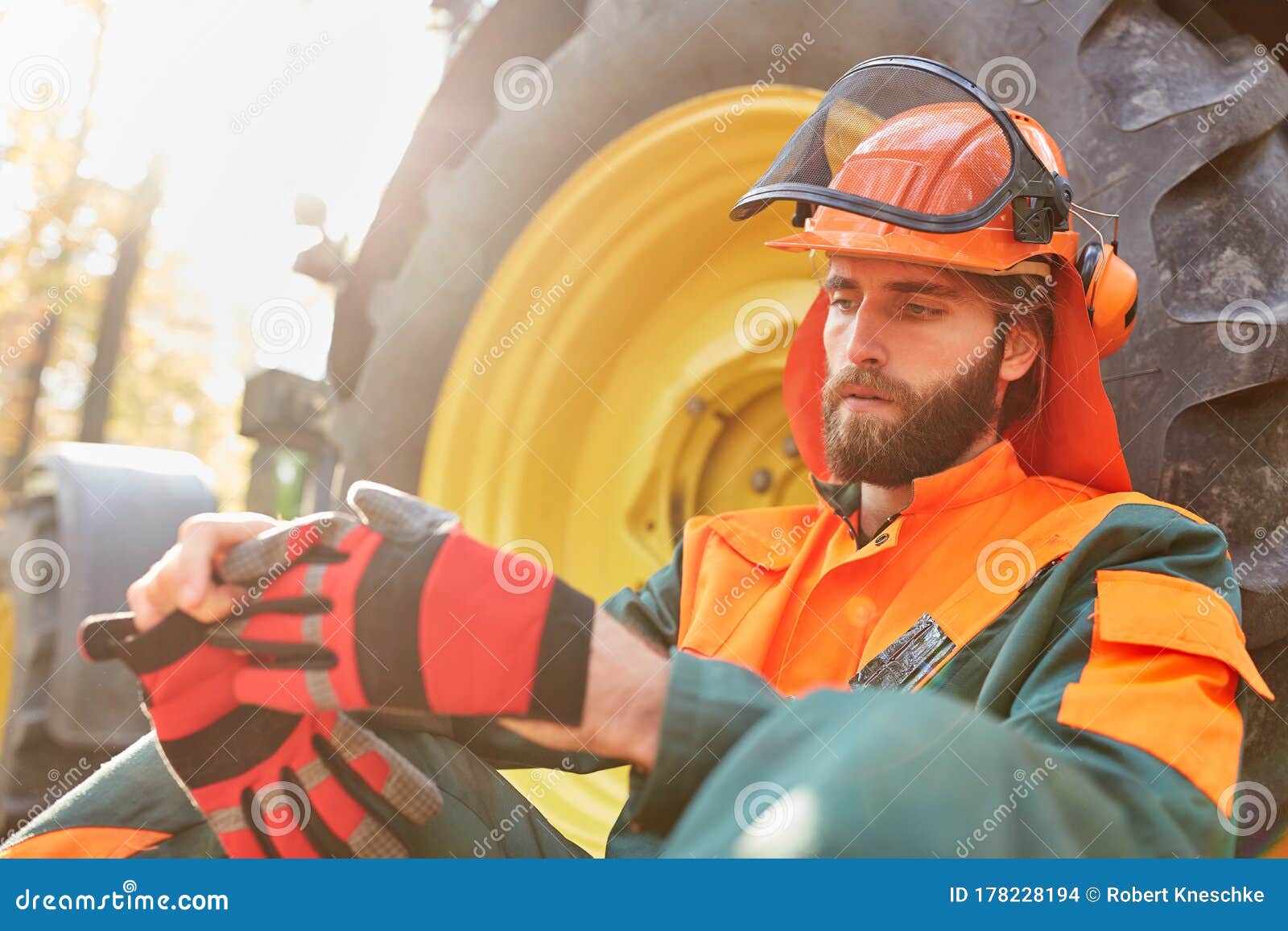 Tired Forest Worker is Leaning Against the Tractor Stock Photo - Image ...