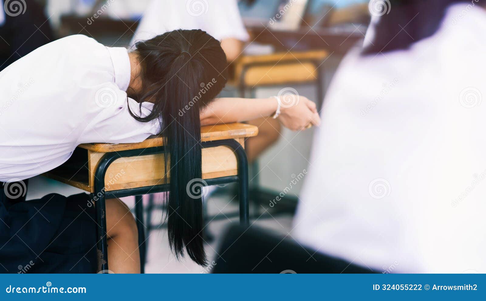 Tired Girl in Uniform Student Sleeping in a Exam Test in Classroom with ...