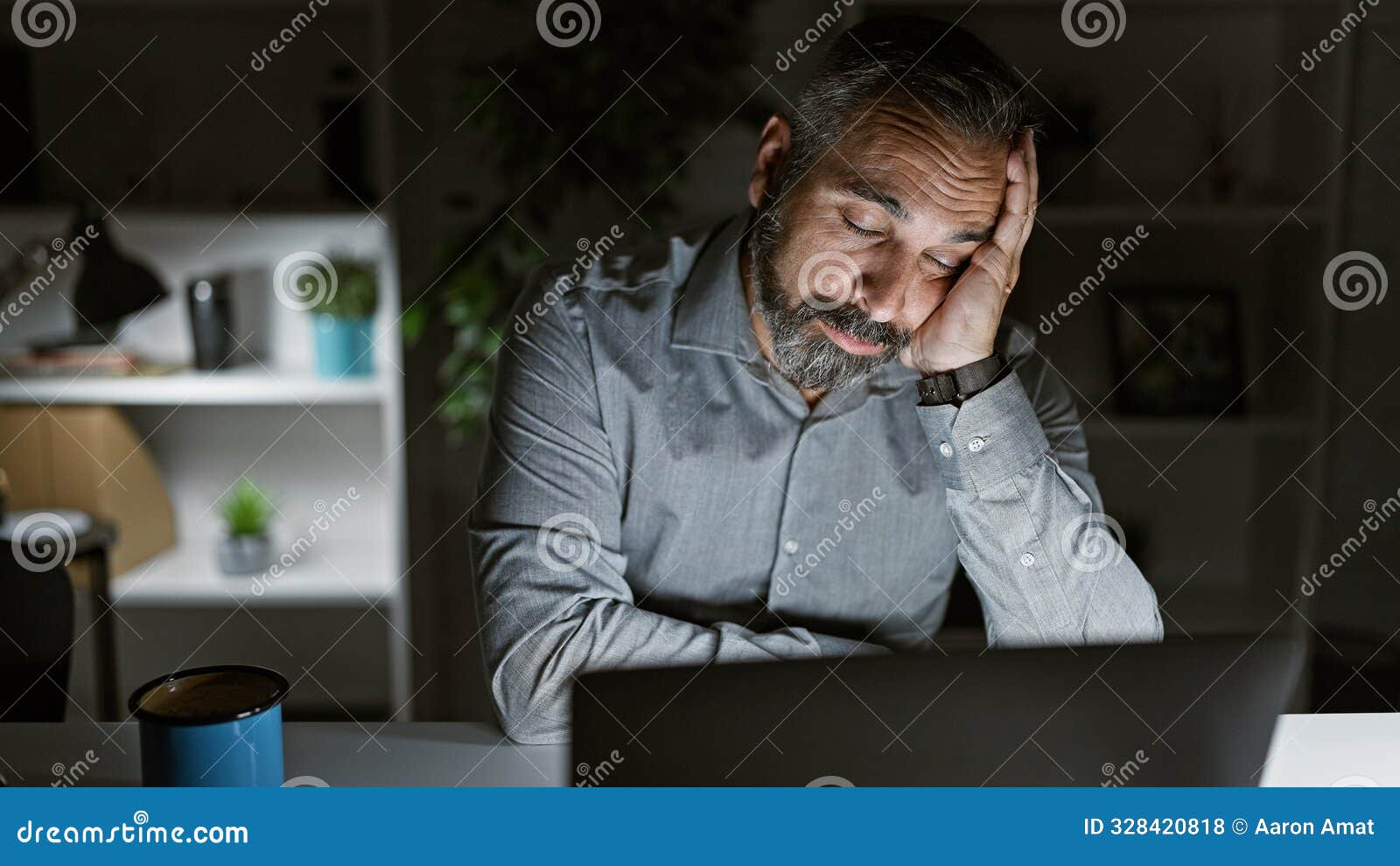 A Tired Hispanic Man with Grey Beard in a Dark Office Looking Exhausted ...
