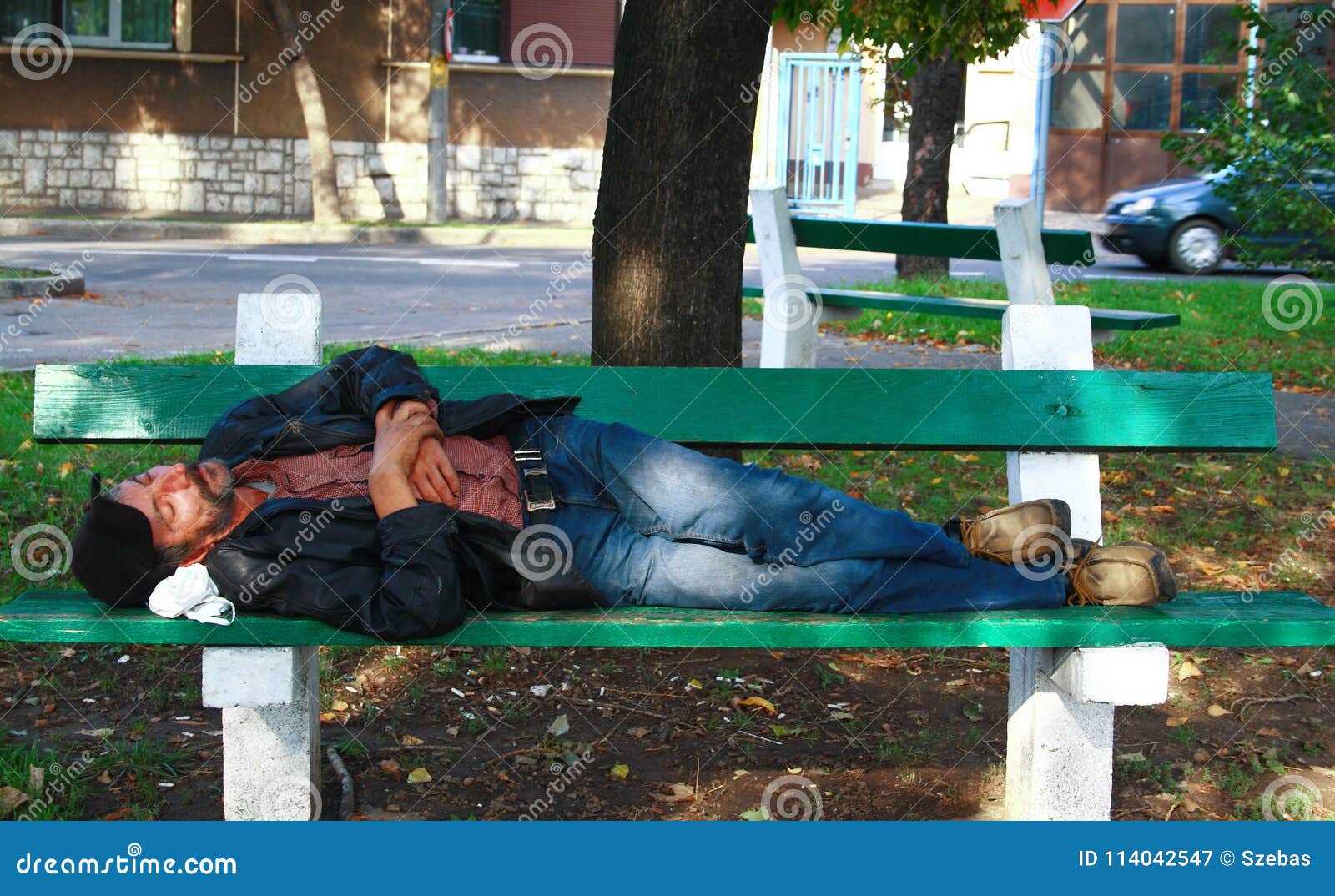 Tired Homeless Man Sleeping on a Bench Editorial Photography - Image of ...
