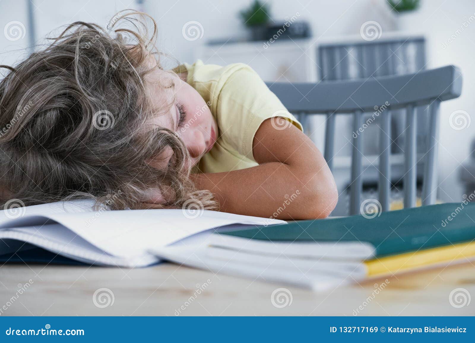 Tired Kid Sleeping with His Head Rested on a Table with a Book Stock ...