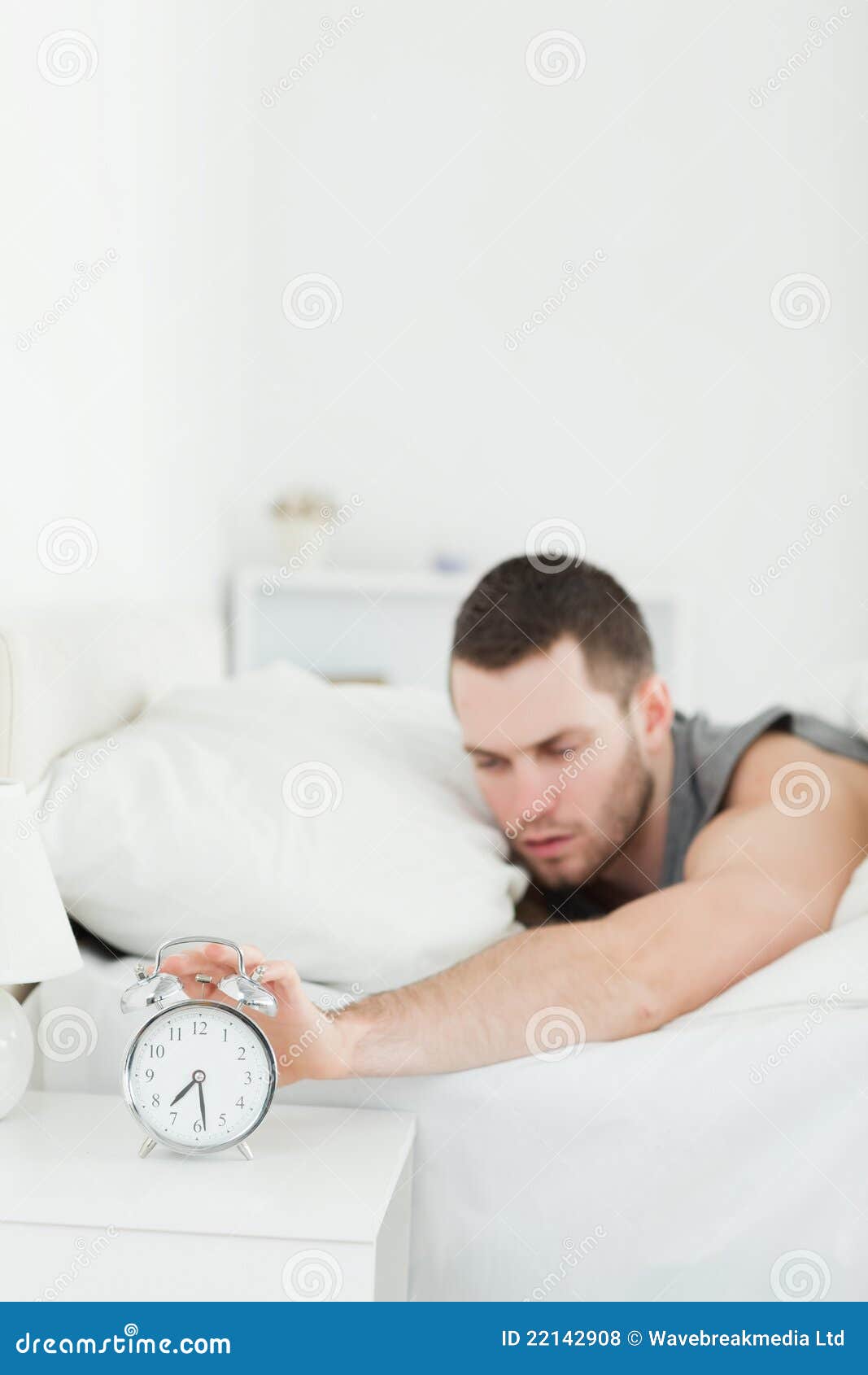 A Tired Man Being Awakened by an Alarm Clock Stock Photo - Image of ...