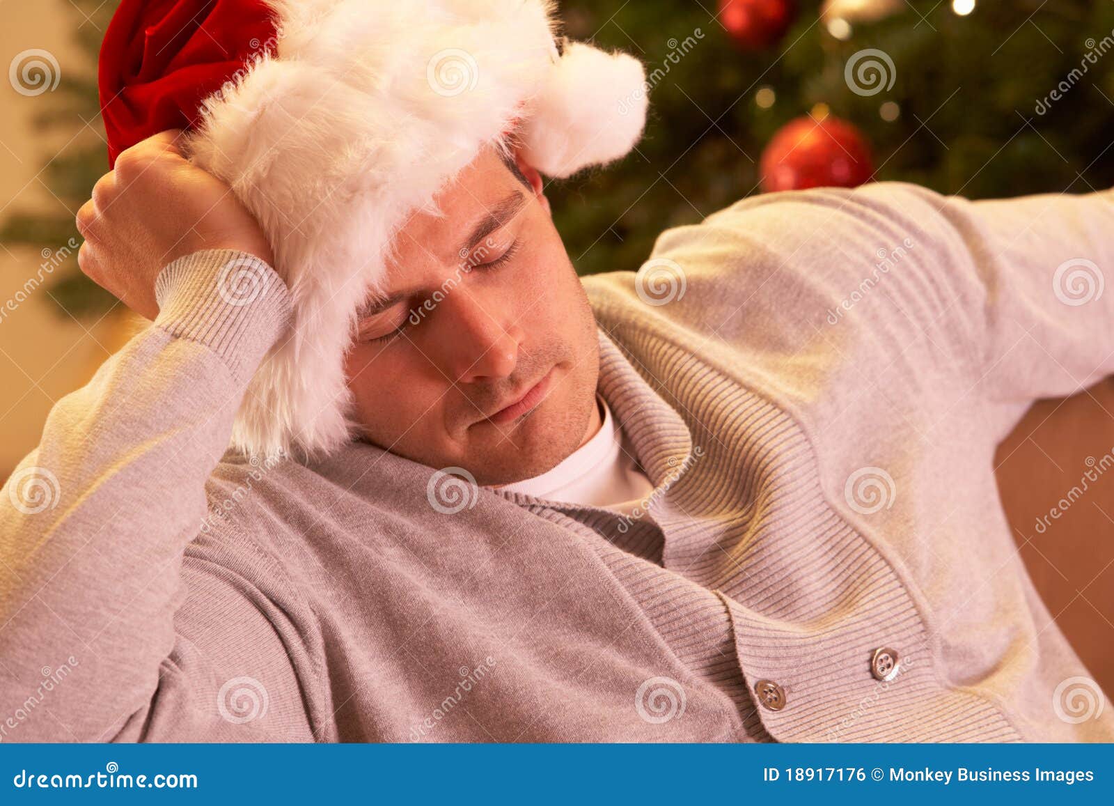 Tired Man Relaxing in Front of Christmas Tree Stock Photo - Image of ...