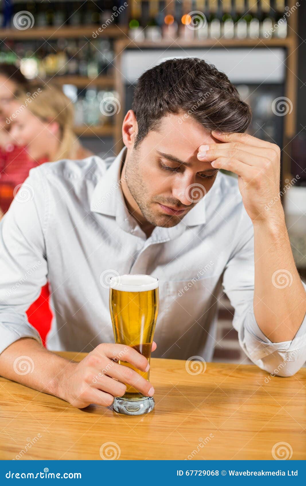 Tired man sitting in a bar stock photo. Image of leisure - 67729068