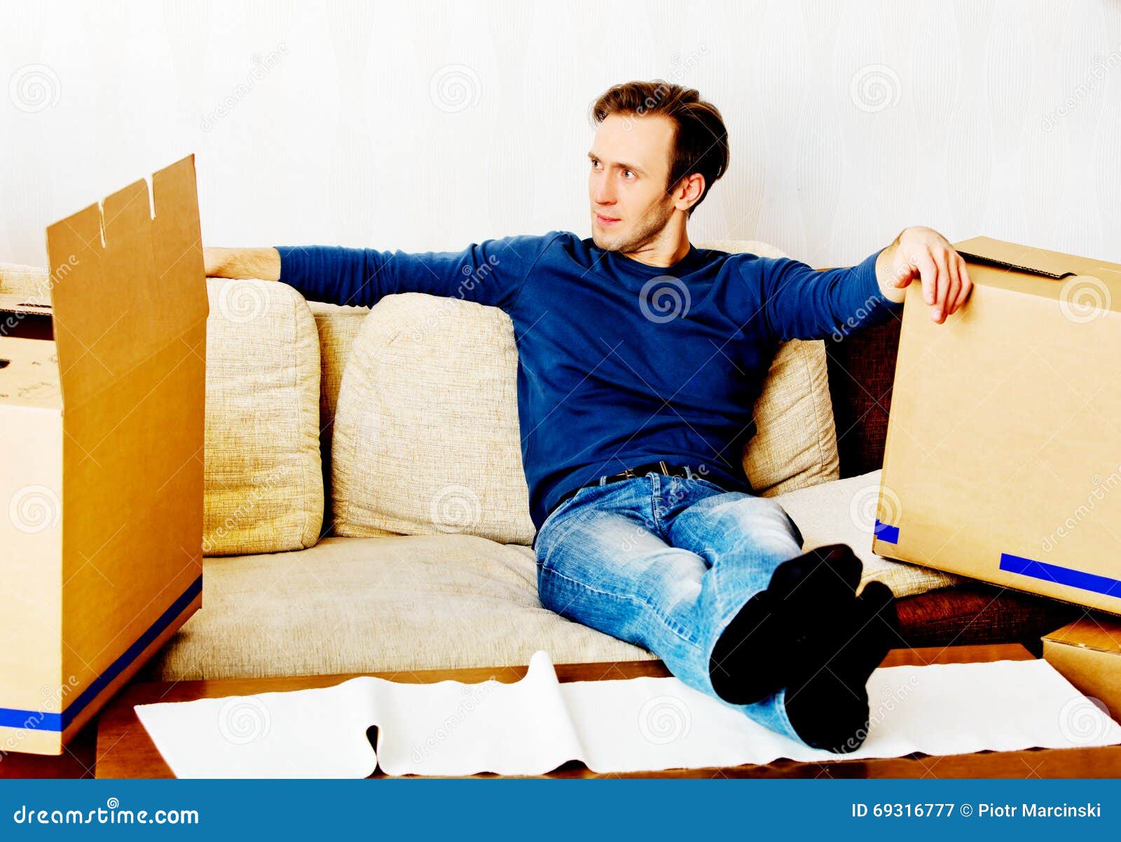 Tired Man Sitting on Couch with Cardboard Boxes Around Stock Image ...