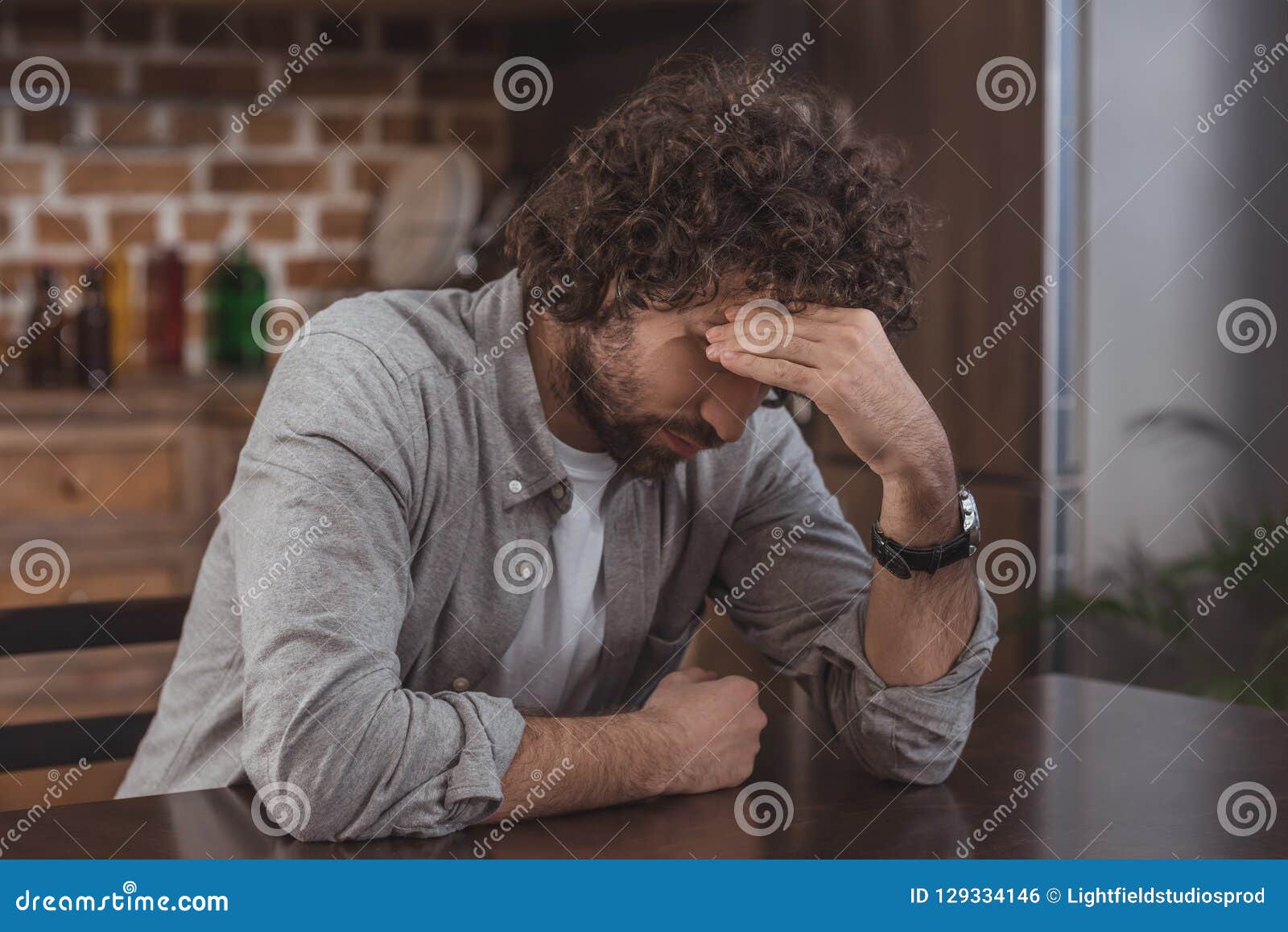 Tired Man Sitting at Table in Kitchen Stock Photo - Image of indoors ...