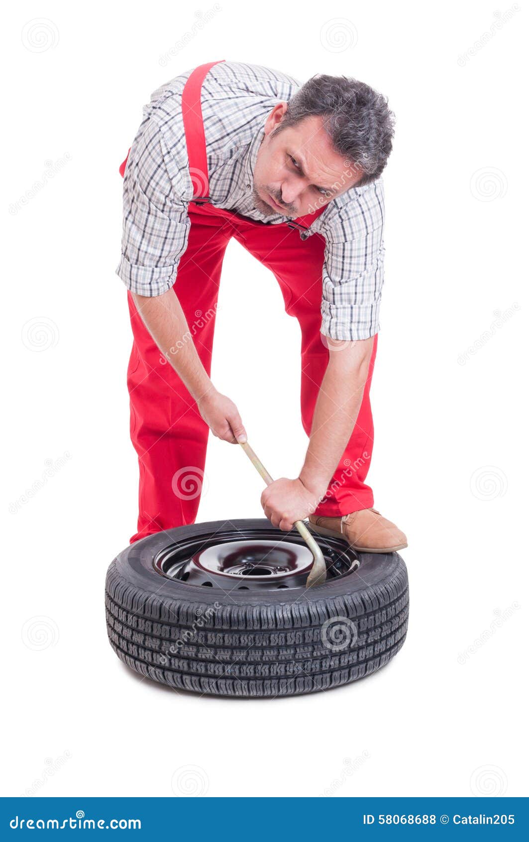 Tired Mechanic Changing a New Tire Stock Photo - Image of male ...